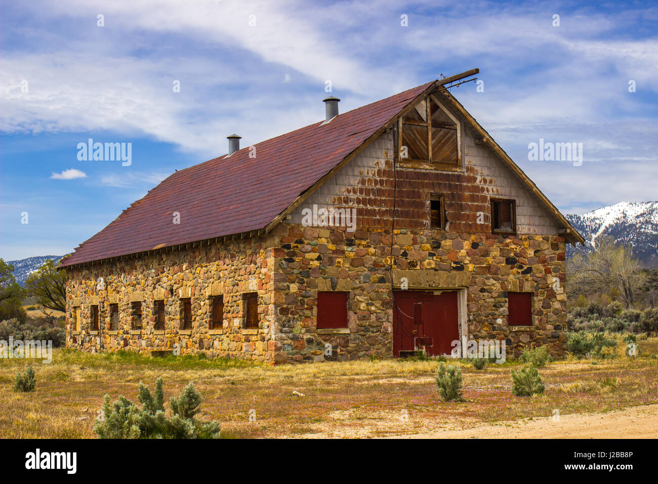 Boarded Up Barn With River Rock Siding In High Desert Stock Photo - Alamy