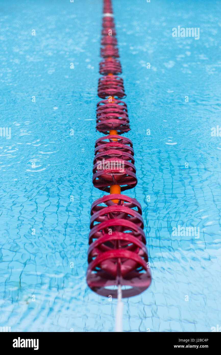 Swimming bath with red floats and clear blue water Stock Photo - Alamy