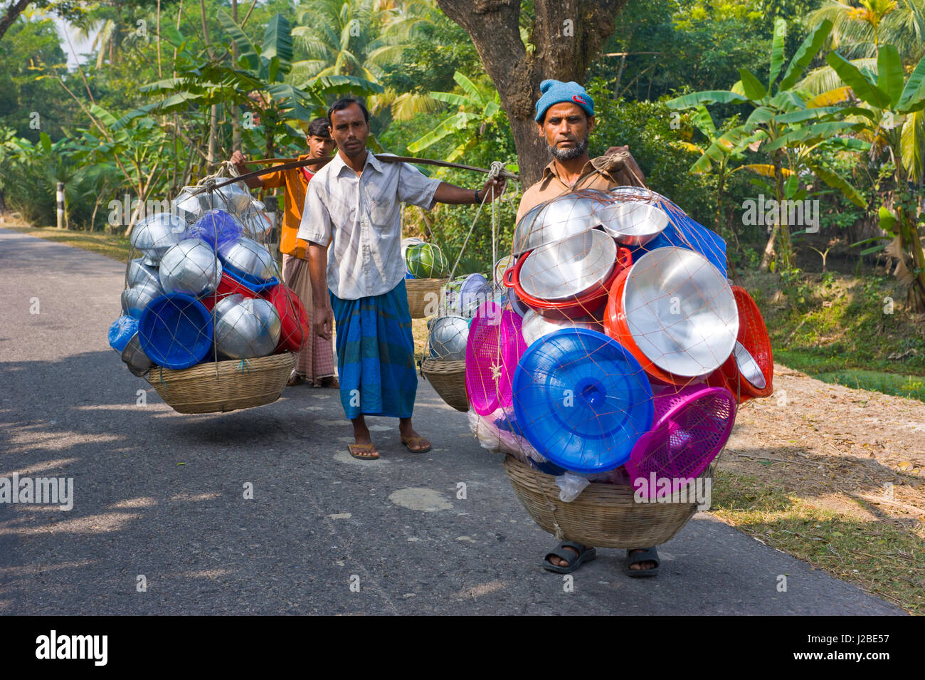 Man carrying lots of steel pots, Bangladesh, Asia Stock Photo - Alamy