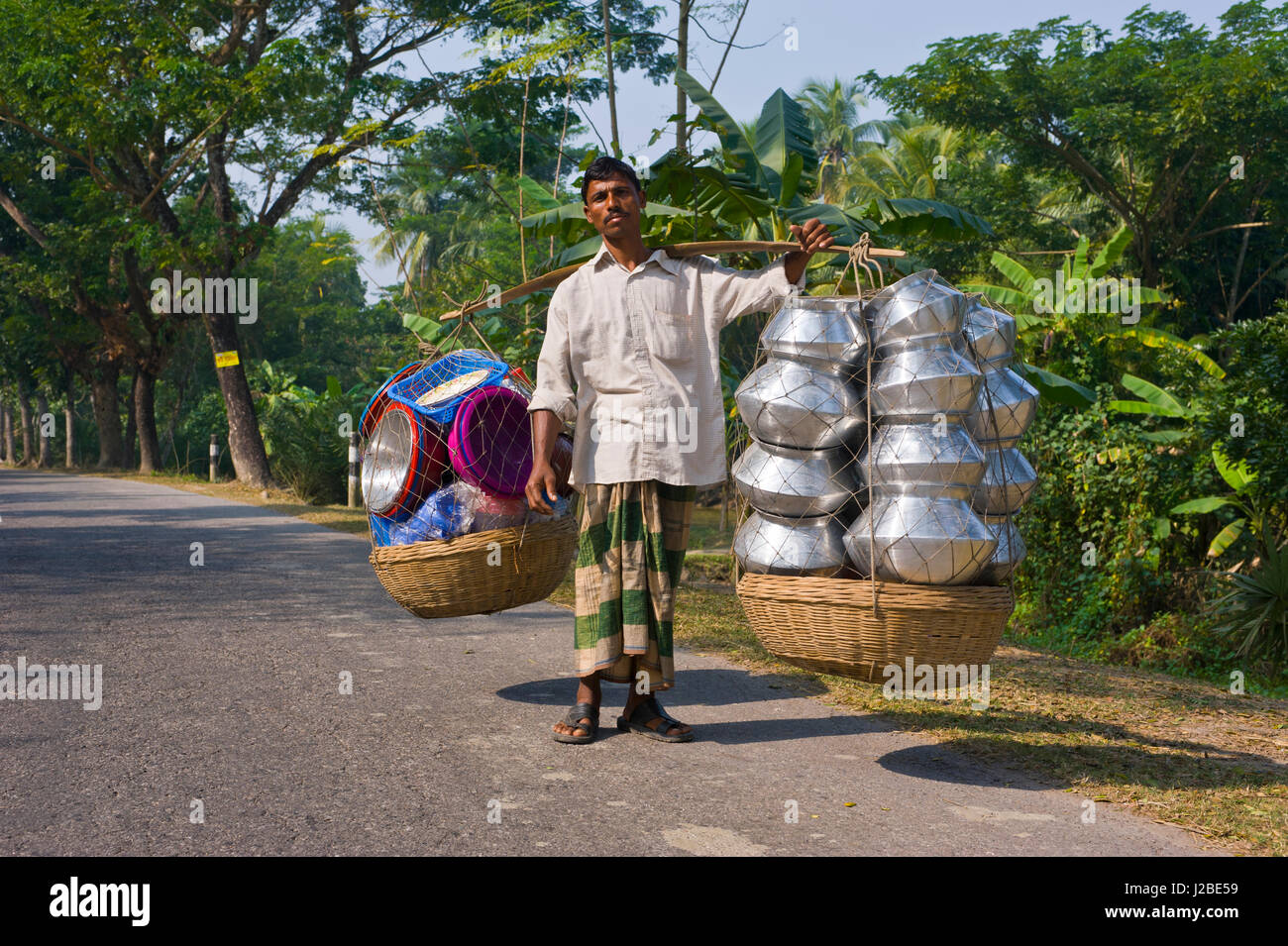 Man carrying lots of steel pots, Bangladesh, Asia Stock Photo - Alamy