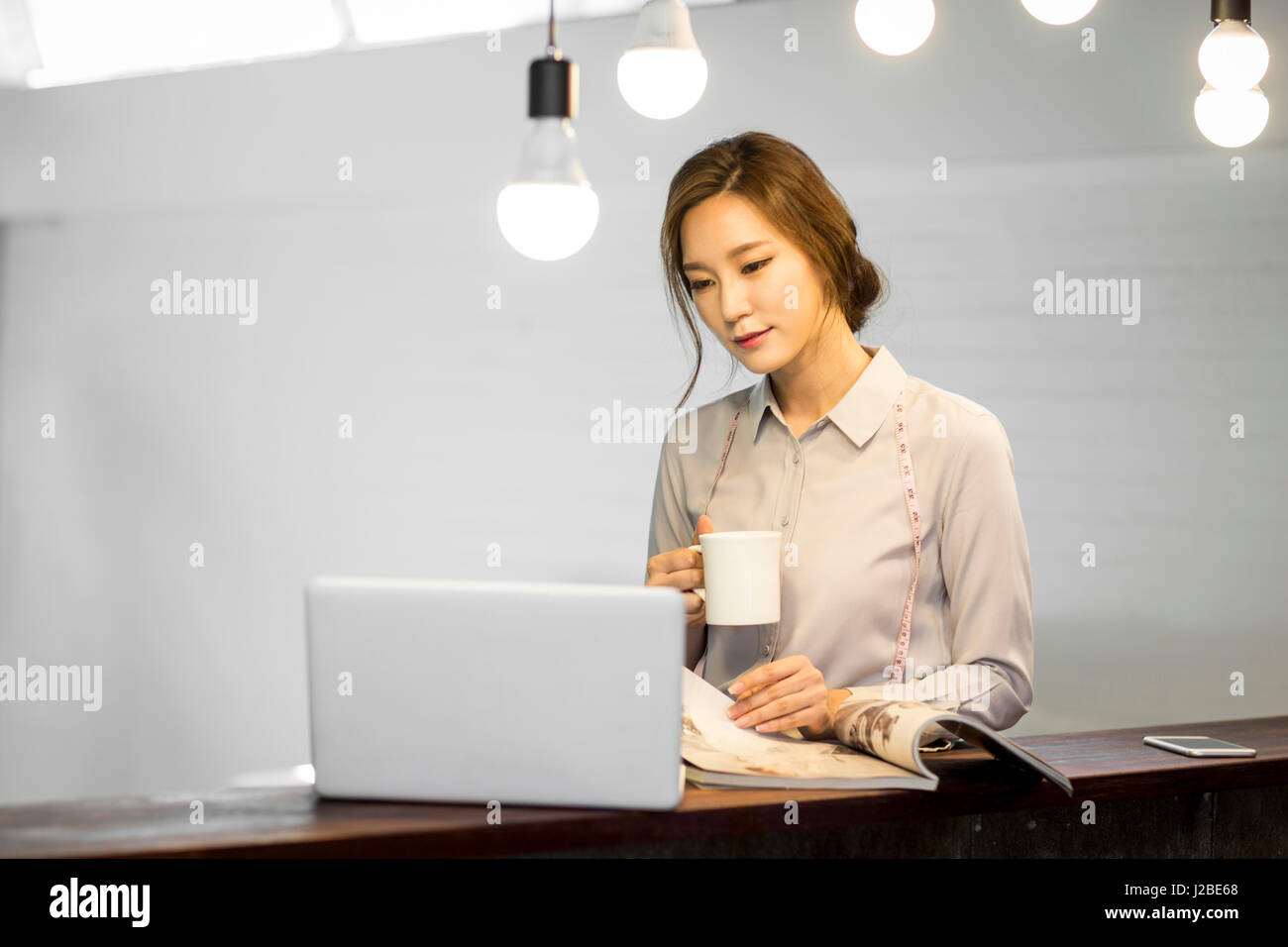 Female fashion designer using a laptop Stock Photo - Alamy