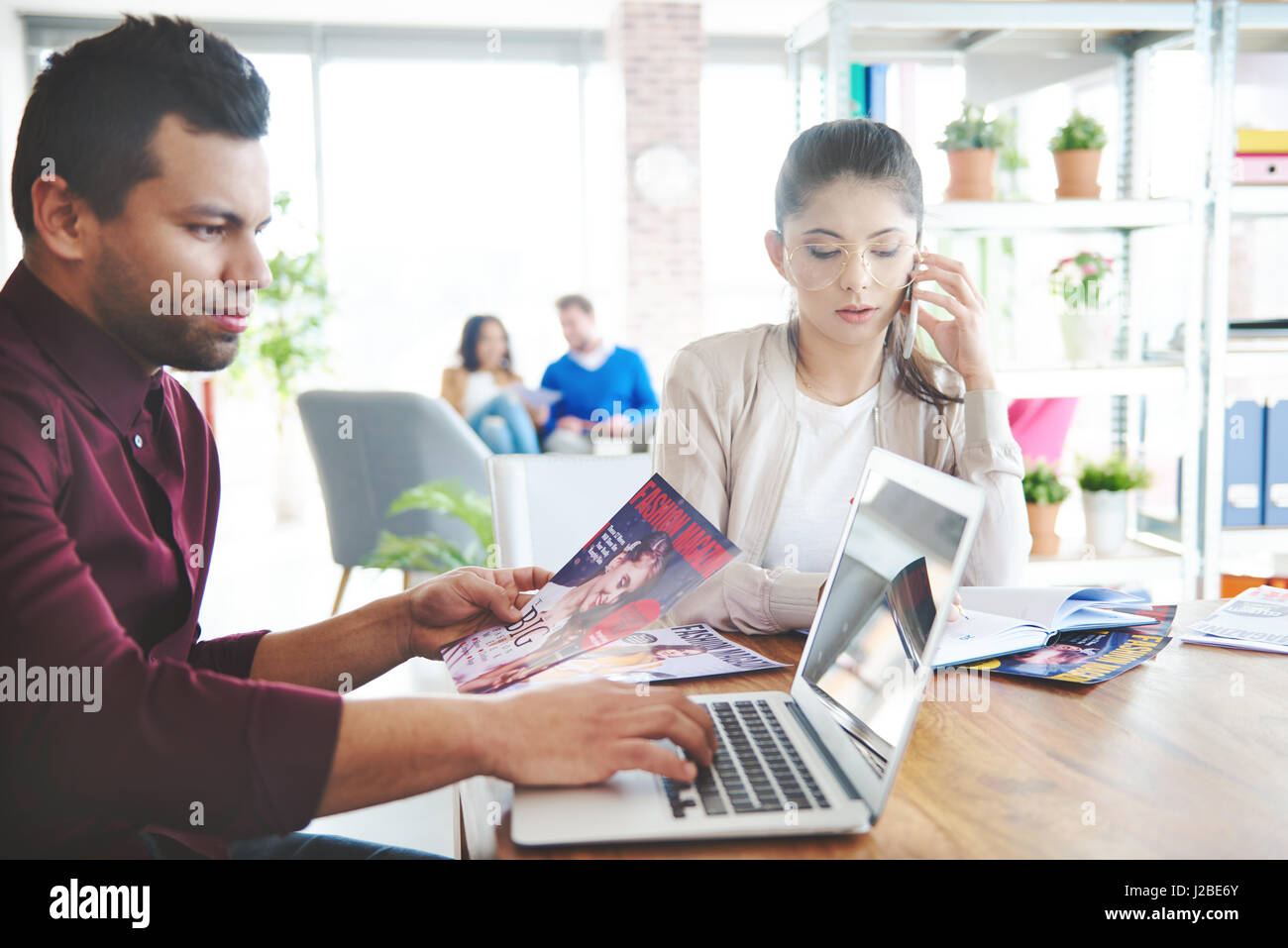 Two coworkers using wireless technology at work Stock Photo - Alamy
