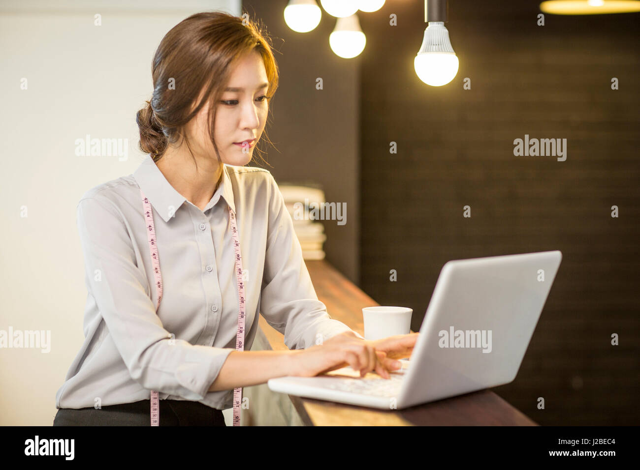 Female designer using na laptop Stock Photo - Alamy