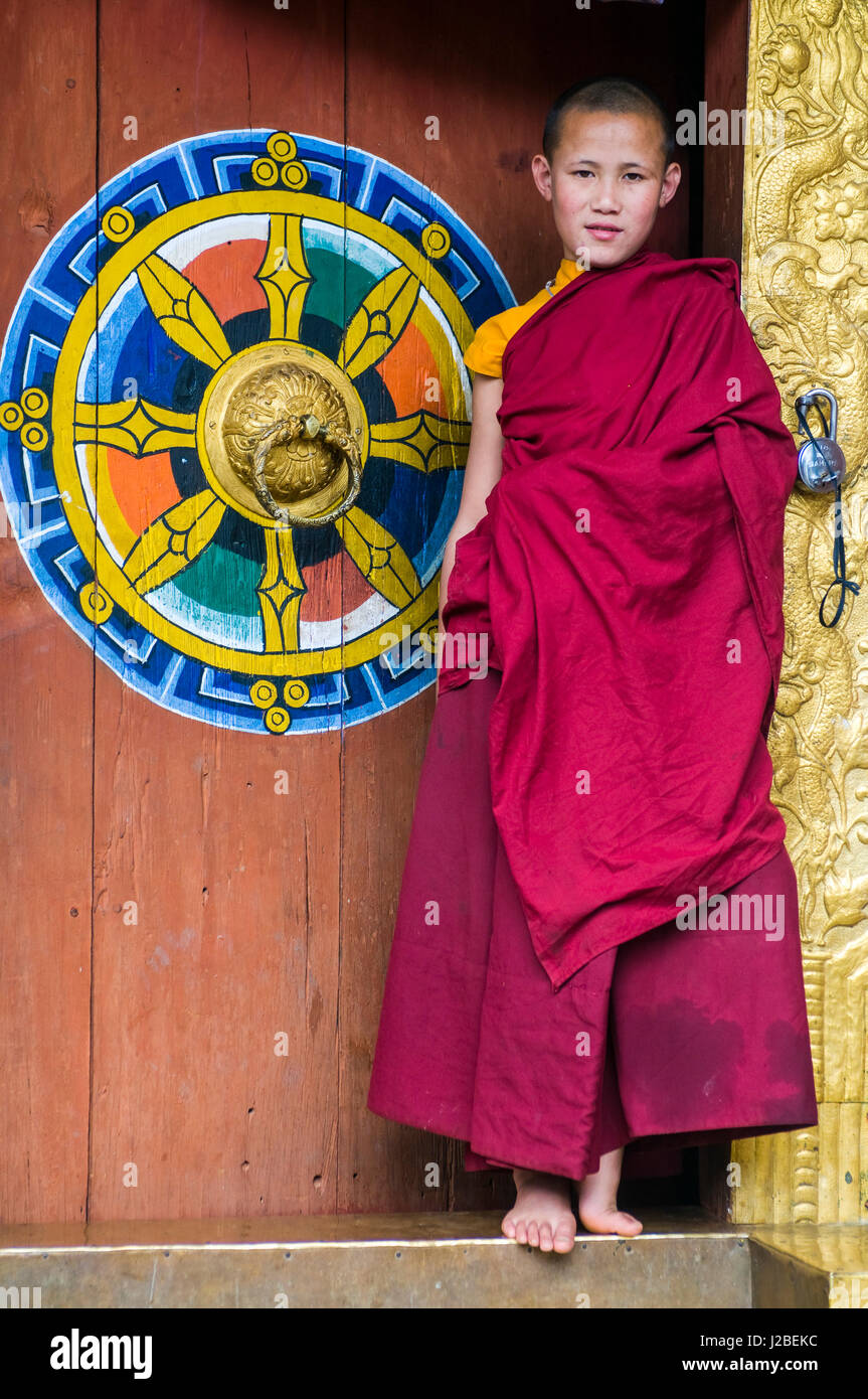 Young monk standing in the doorway, Chimi Lhakhang, Bhutan Stock Photo ...