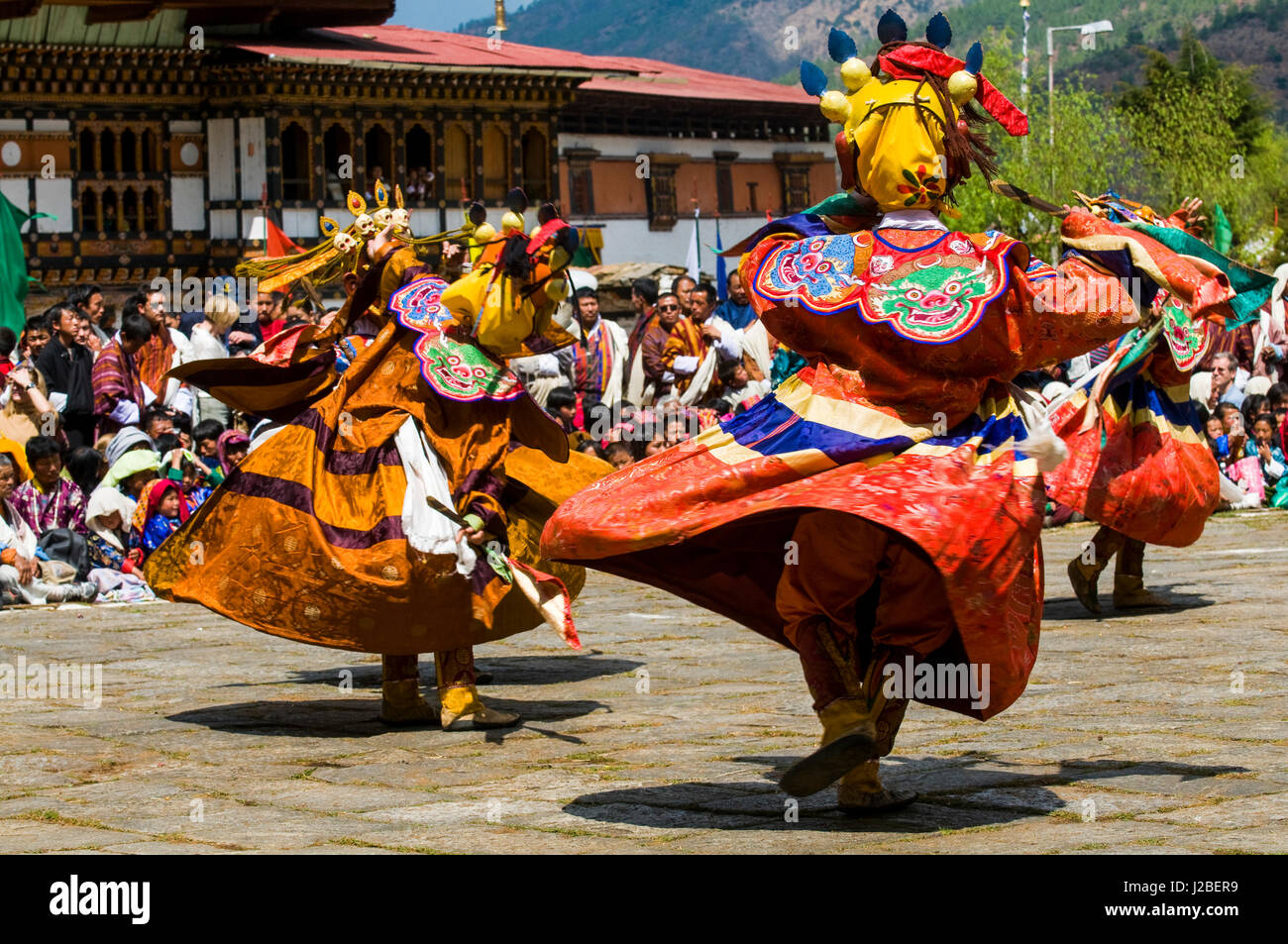 Costumed dancers at religious festivity with many visitors, Paro ...