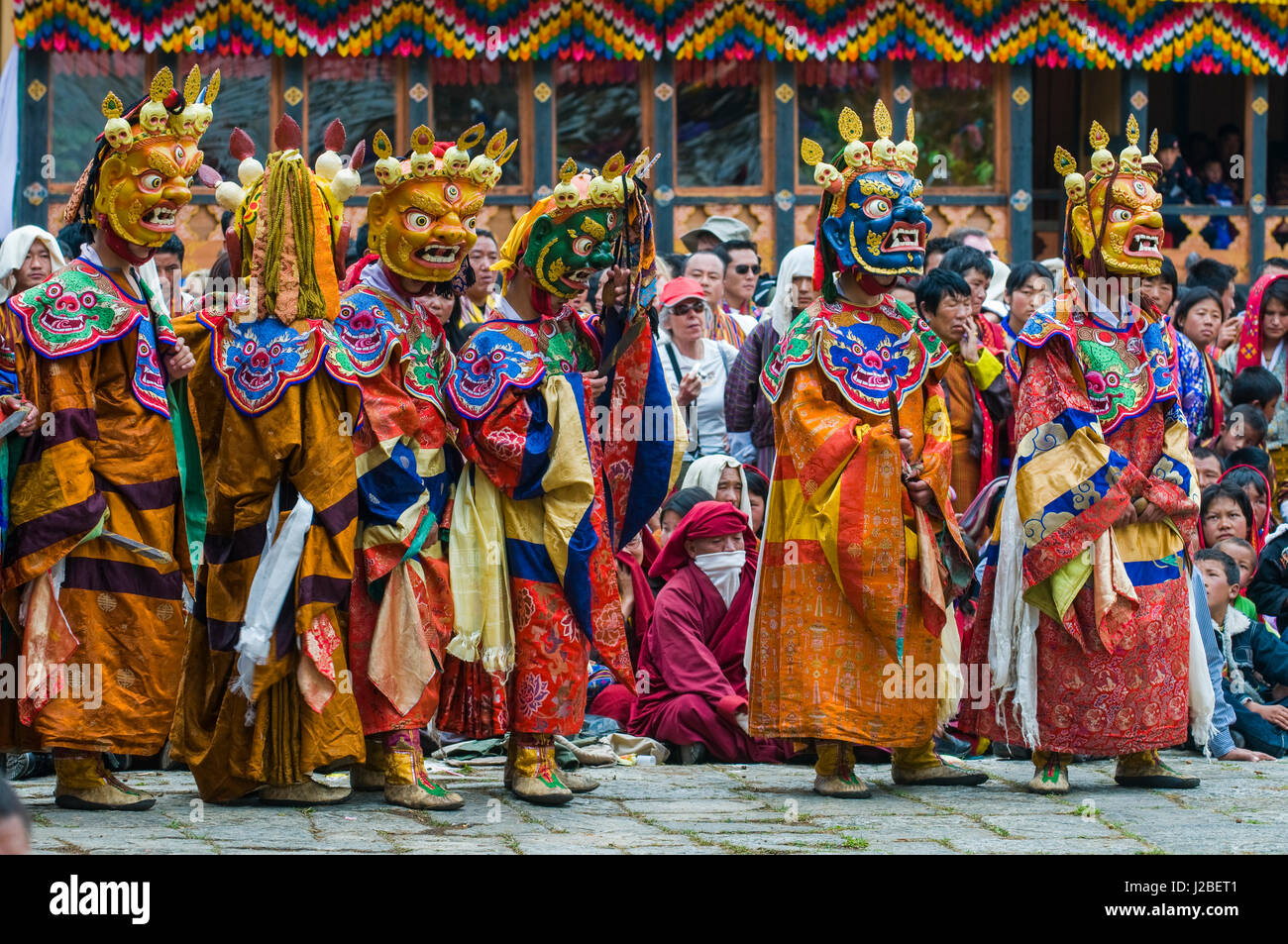 Costumed dancers at religious festivity with many visitors, Paro ...