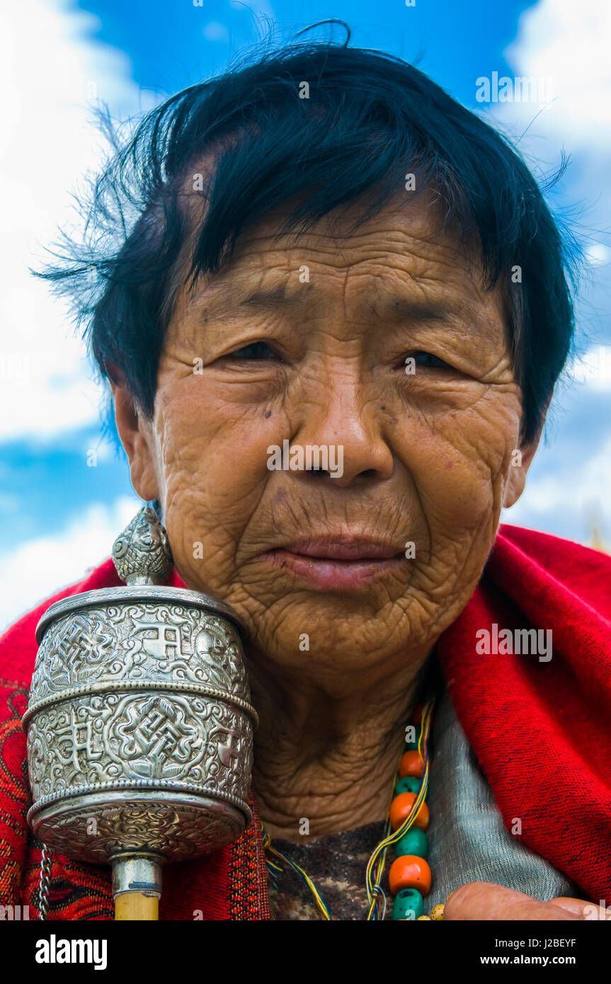 Religious Buddhist woman with praying wheels, Thimphu, Bhutan Stock ...