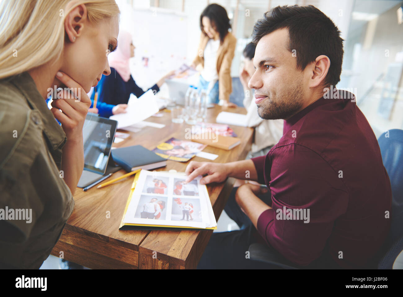 Two colleagues making a comparison Stock Photo - Alamy