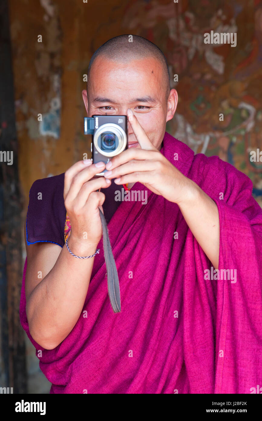 Monk with camera, Bhutan Stock Photo - Alamy
