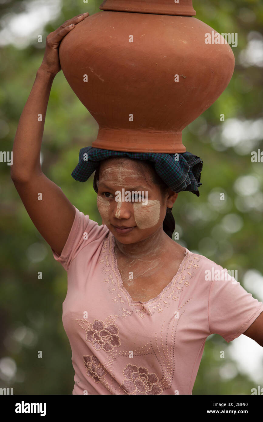 Mandalay young woman carrying pot hi-res stock photography and images ...