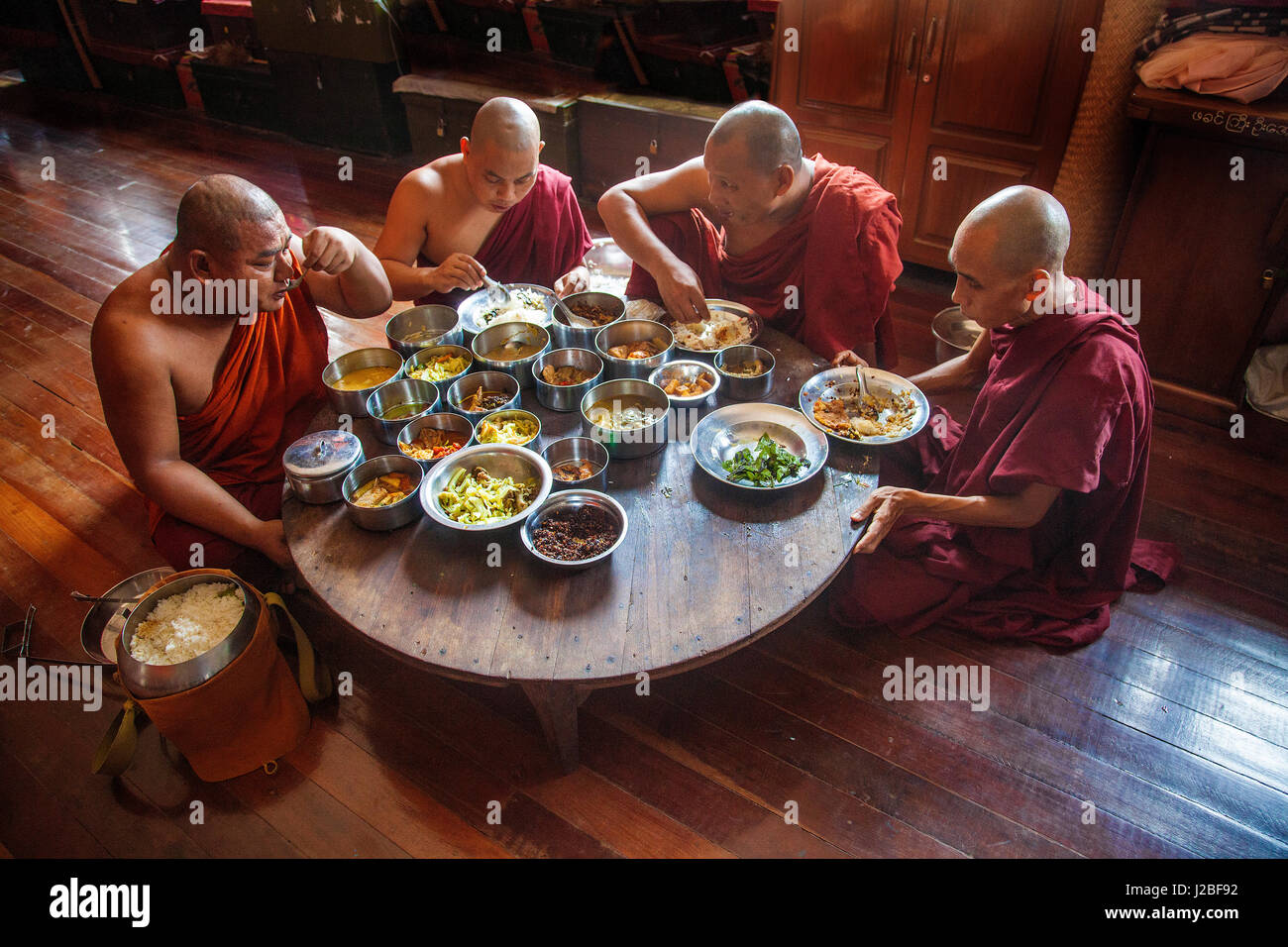 Myanmar, Mandalay. Buddhist monks eating in temple. Credit as: Jim ...