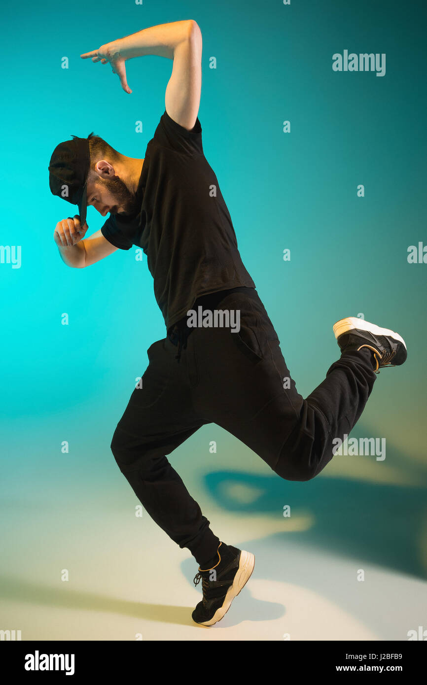 The silhouette of one hip hop male break dancer dancing on colorful ...