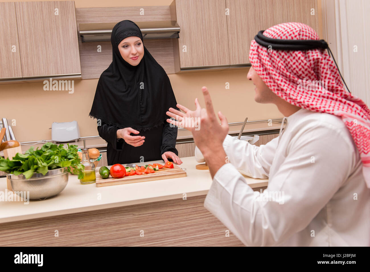Young arab family in the kitchen Stock Photo - Alamy