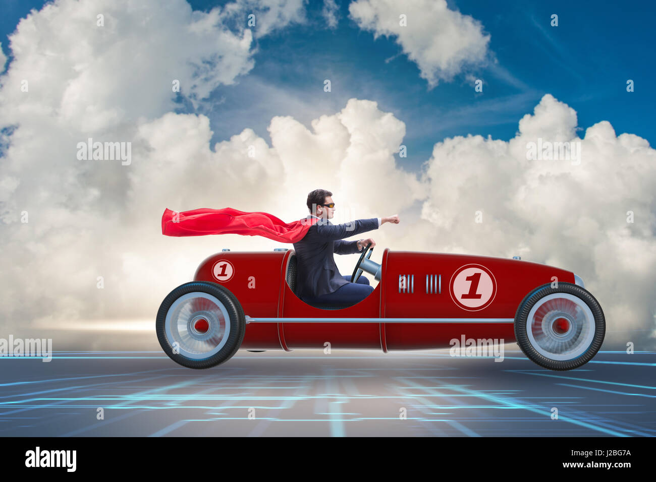 Superhero businessman driving vintage roadster Stock Photo - Alamy