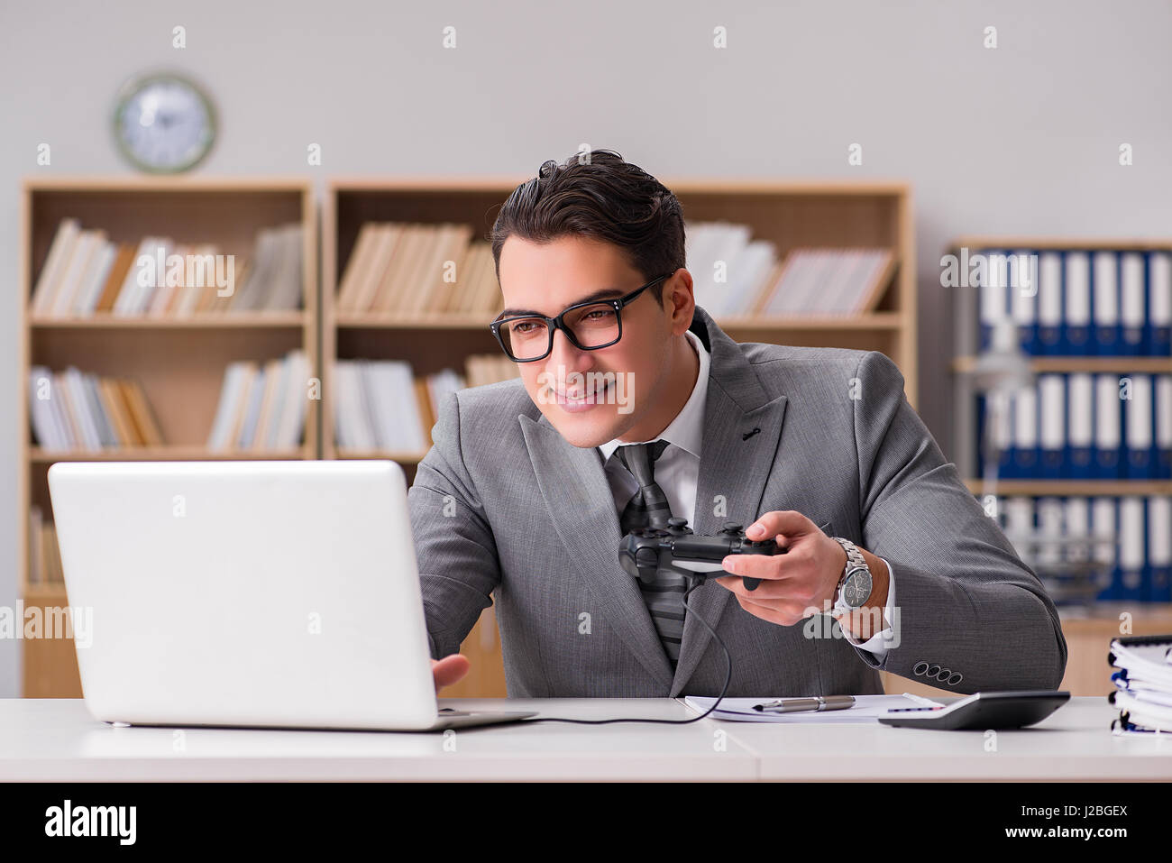 Businessman playing computer games at work office Stock Photo - Alamy