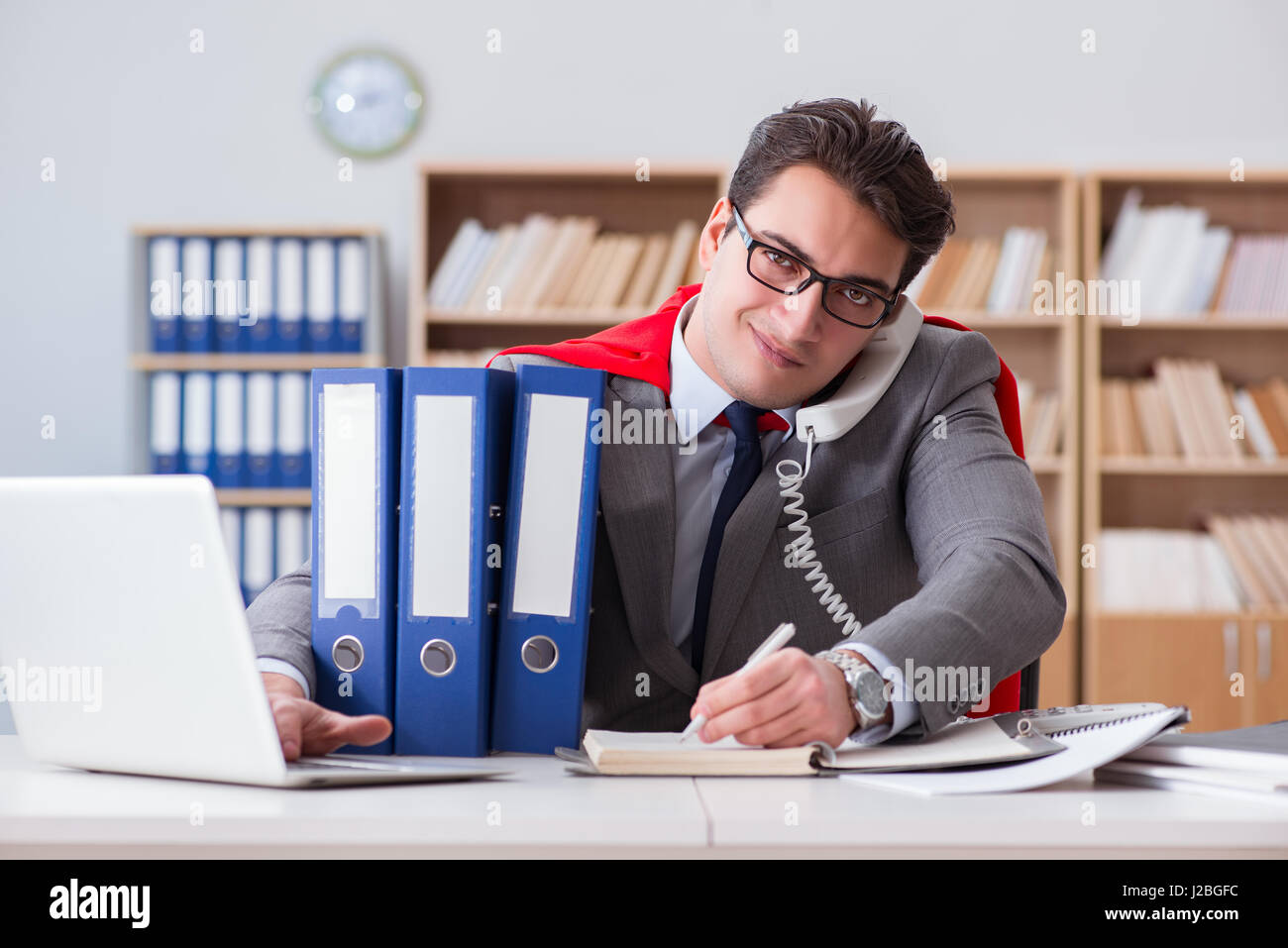 Superhero businessman working in the office Stock Photo - Alamy