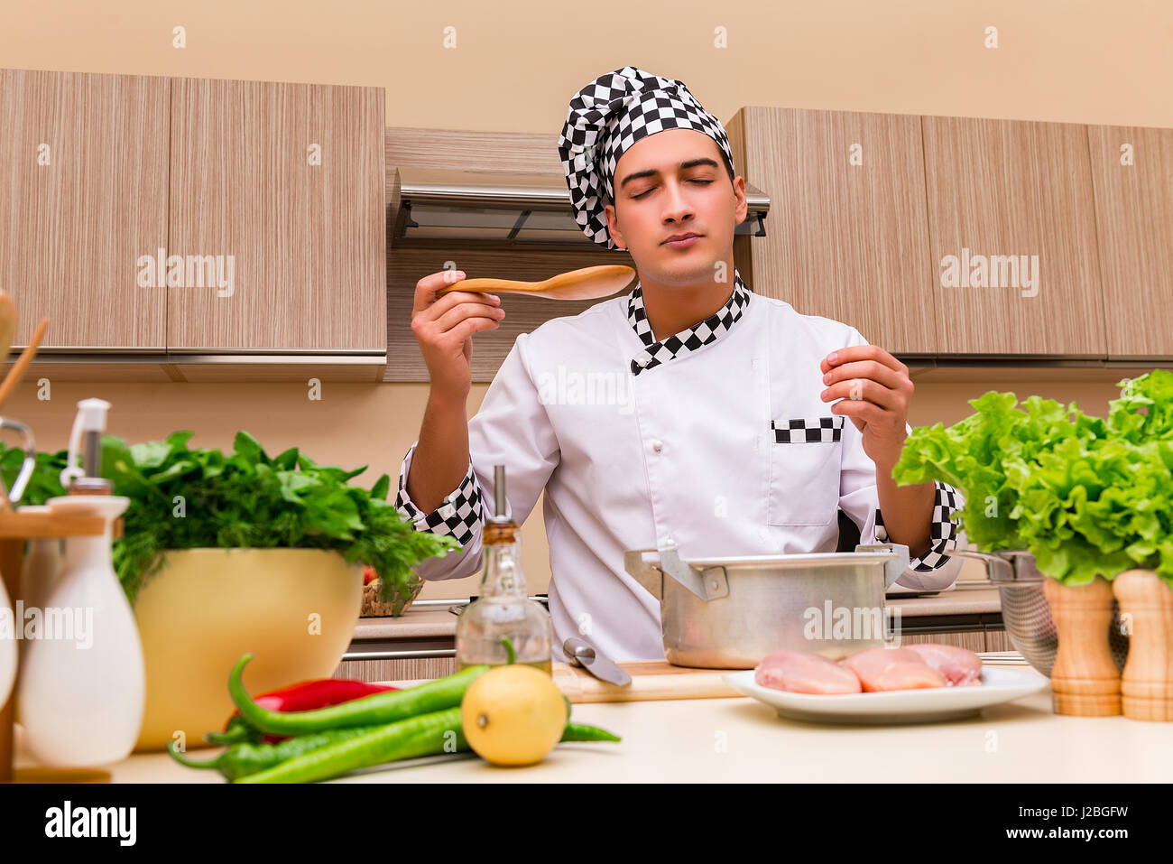 Young chef working in the kitchen Stock Photo - Alamy