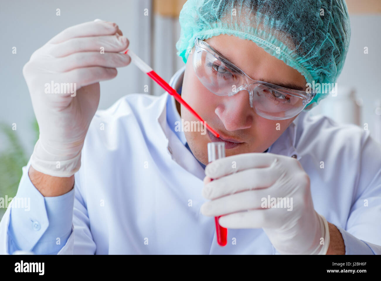 Young doctor working on blood test in lab hospital Stock Photo - Alamy