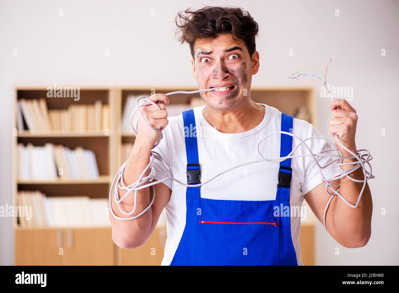 Funny Man doing electrical repairs at home Stock Photo - Alamy