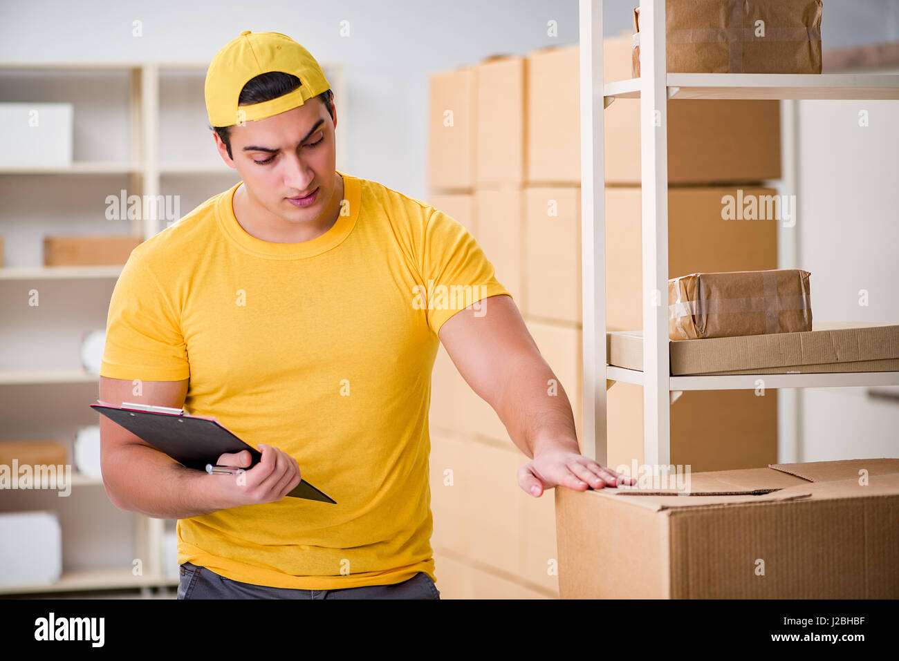 Man working in postal parcel delivery service office Stock Photo - Alamy