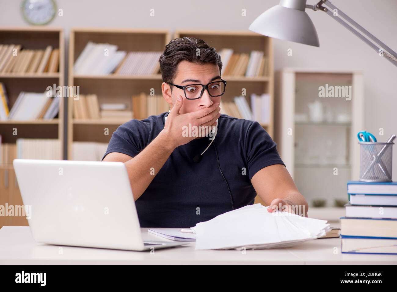Angry man with too much paperwork to do Stock Photo - Alamy