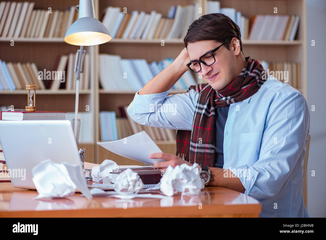 Young book writer writing in library Stock Photo - Alamy