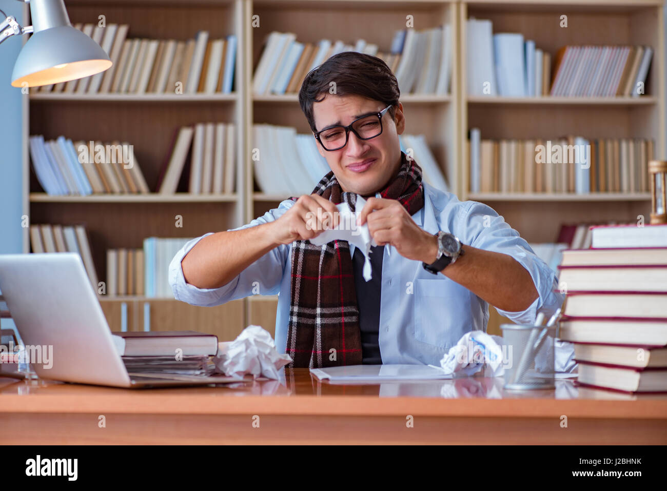 Young book writer writing in library Stock Photo - Alamy