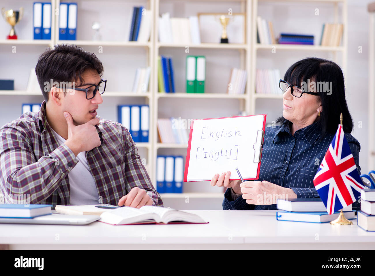 Young foreign student during english language lesson Stock Photo - Alamy