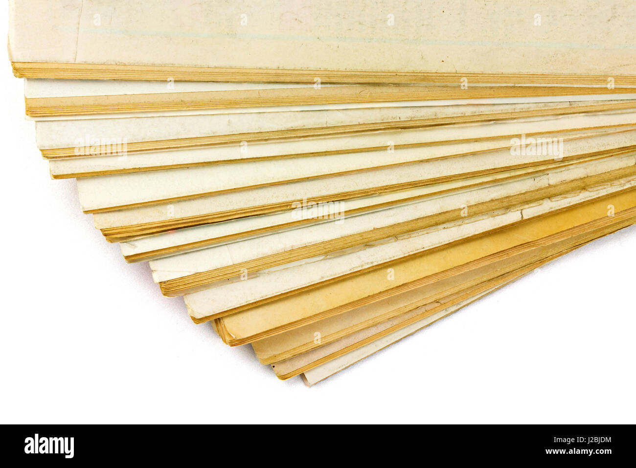 Stack of old vintage comic books with faded yellow pages on white ...