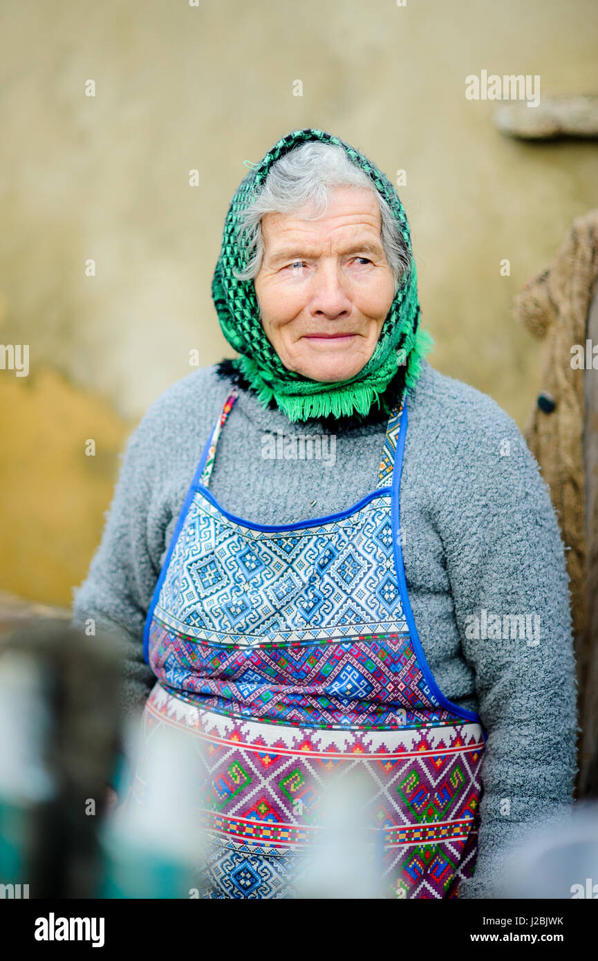 Old peasant woman. Calm, wise sight. gray hair from under a scarf ...