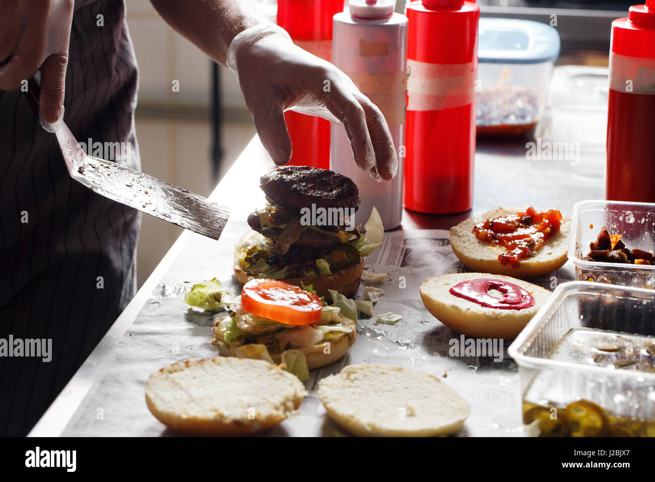 process of cooking hamburger. chef on the kitchen table making out the ...