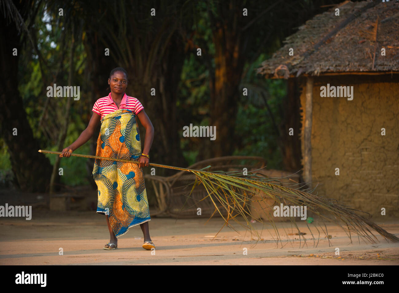 Woman sweeping with palm leaf hi-res stock photography and images - Alamy