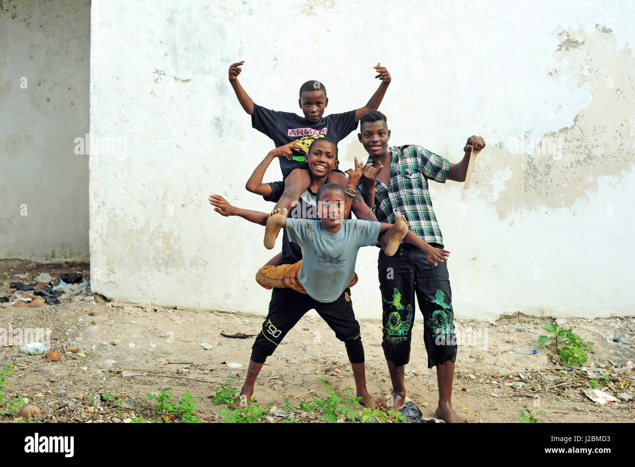 Kenya, Lamu archipelago, Lamu, playful children jumping on each other ...