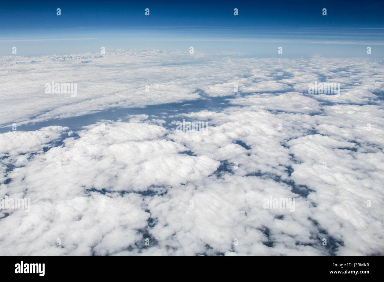 Cloudy skies over europe pictured from high altitude with deep blue ...