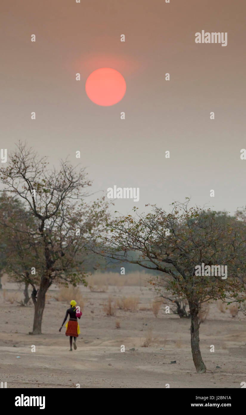 Africa, Namibia, Opuwo. Himba woman walking at sunset. Credit as: Wendy ...