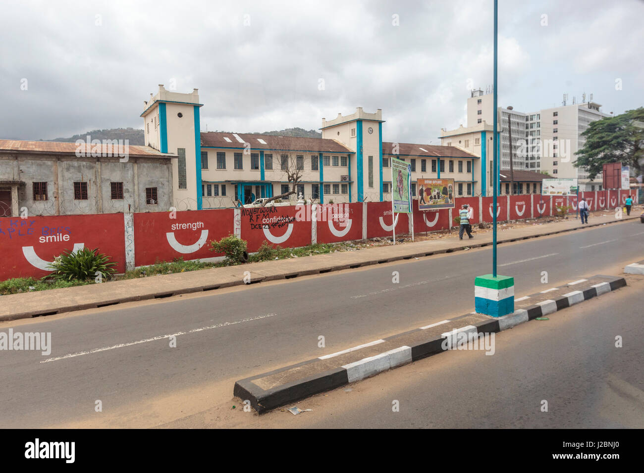 Africa, Sierra Leone, Freetown. A building surrounded by a barbed wire ...