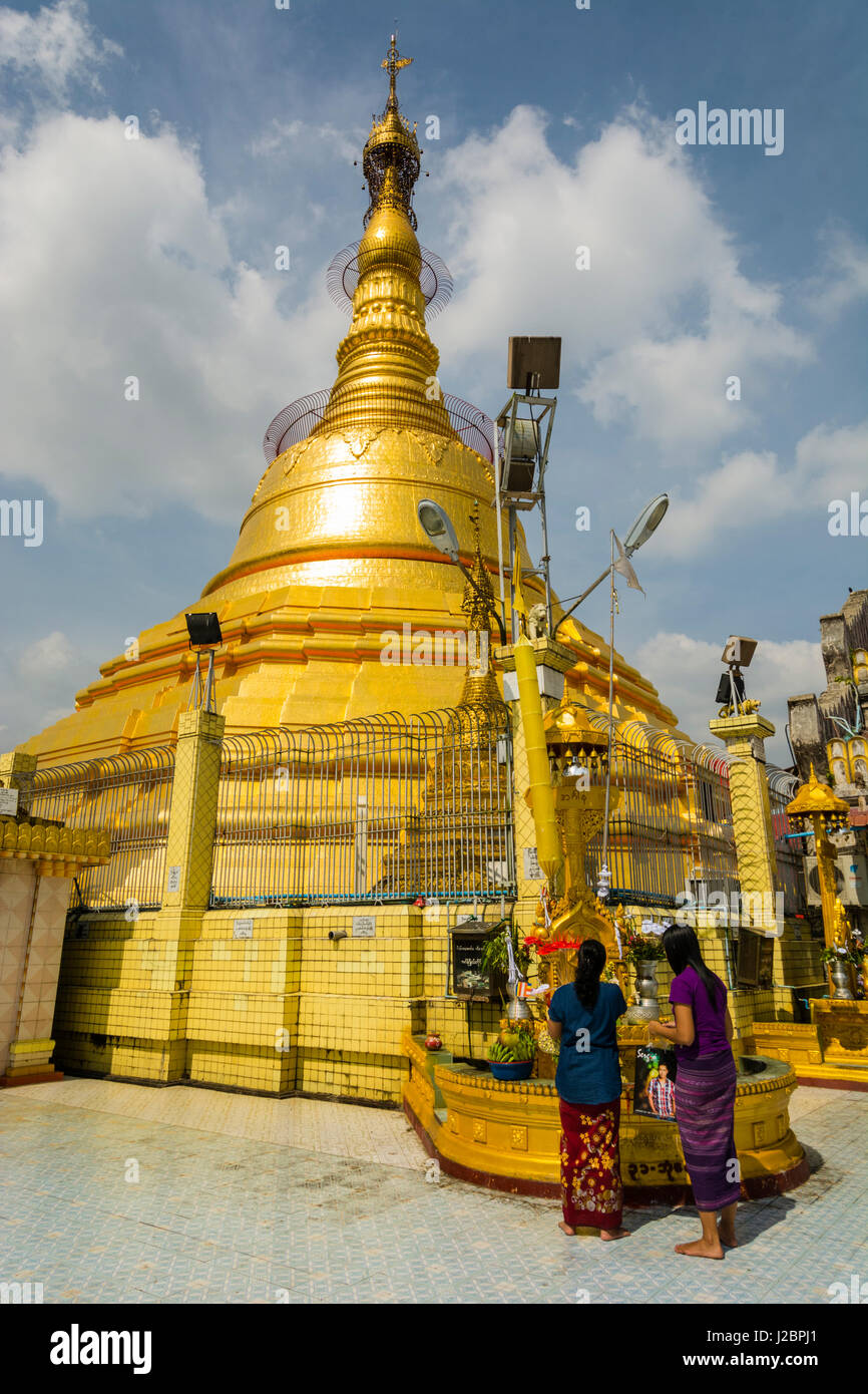 Myanmar. Yangon. Botataung Pagoda. Women placing offerings at the ...