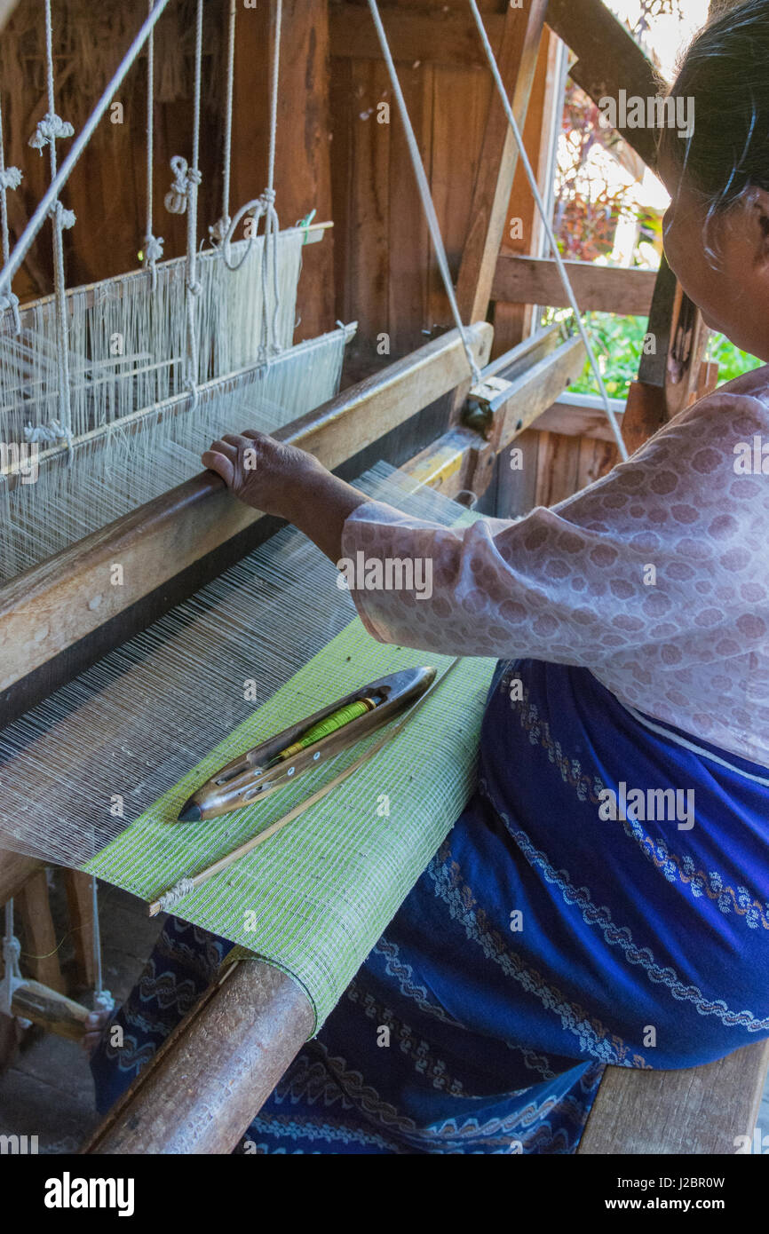 Myanmar. Shan State. Inle Lake. Ko Than Hlaing silk and lotus weaving center. Woman weaving silk ...