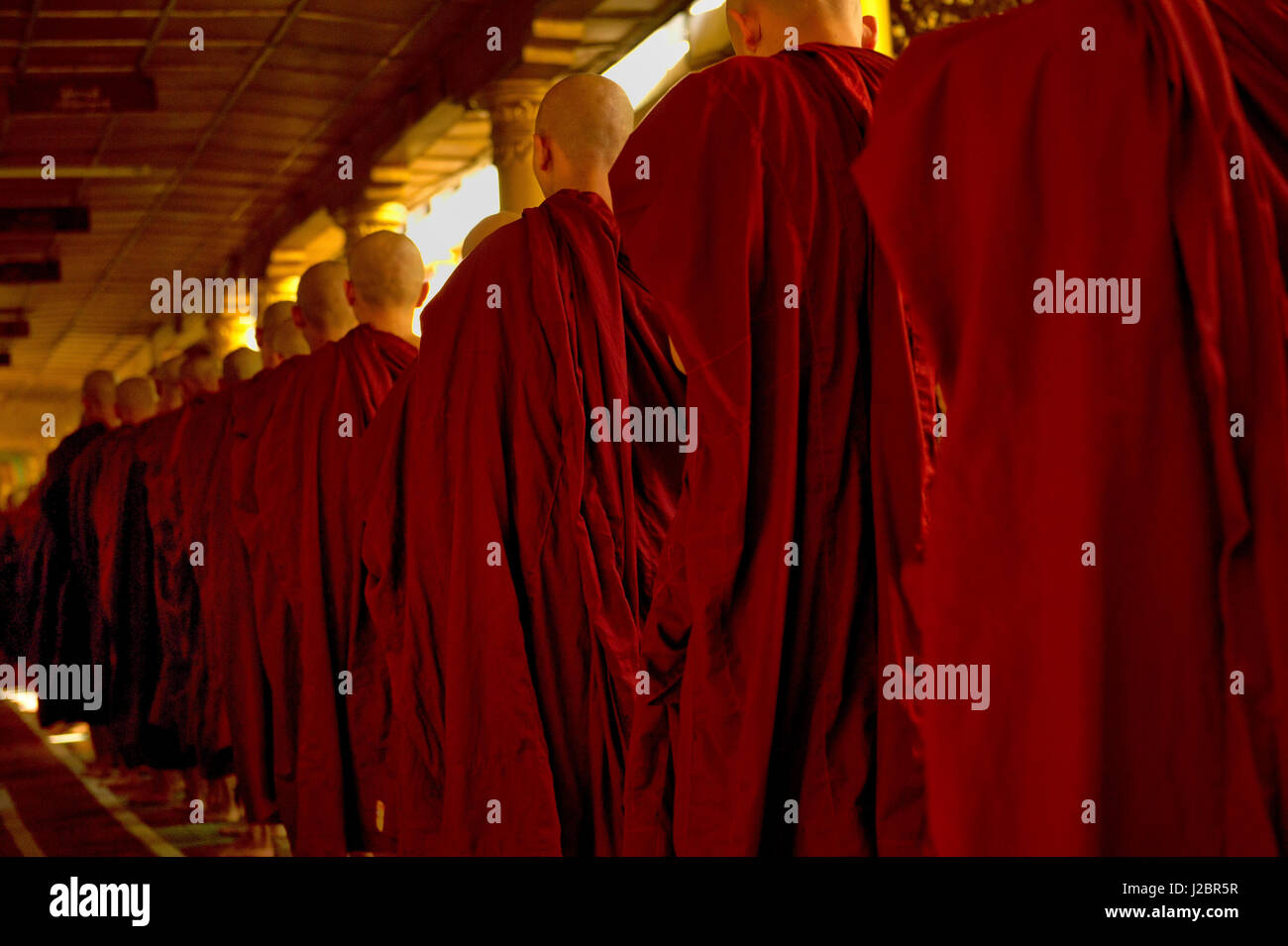 A Buddhist ritual of offering rice to monks in order to earn Karma ...