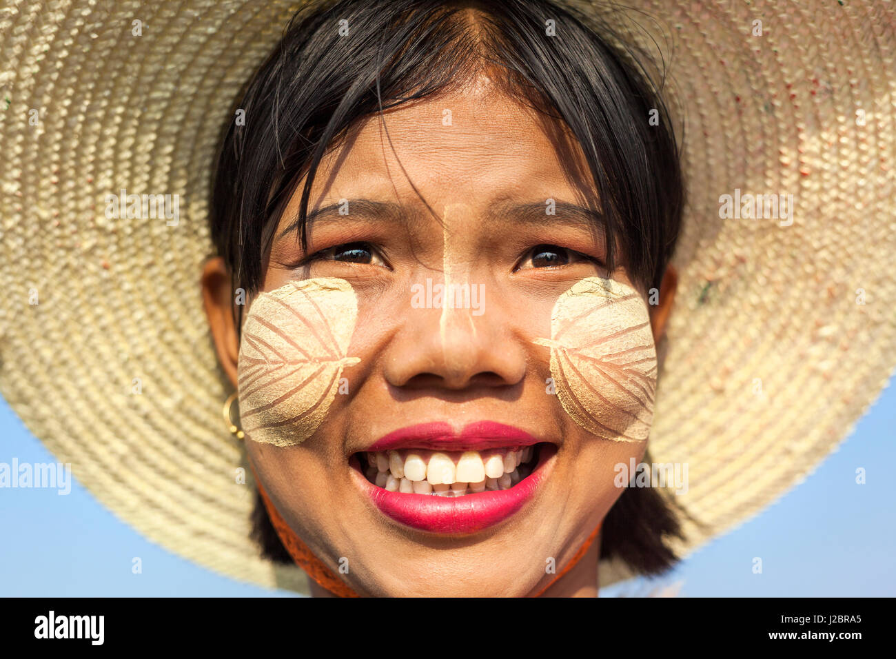 Thanakha paste patterns on face to protect skin from the sun, Mandalay ...