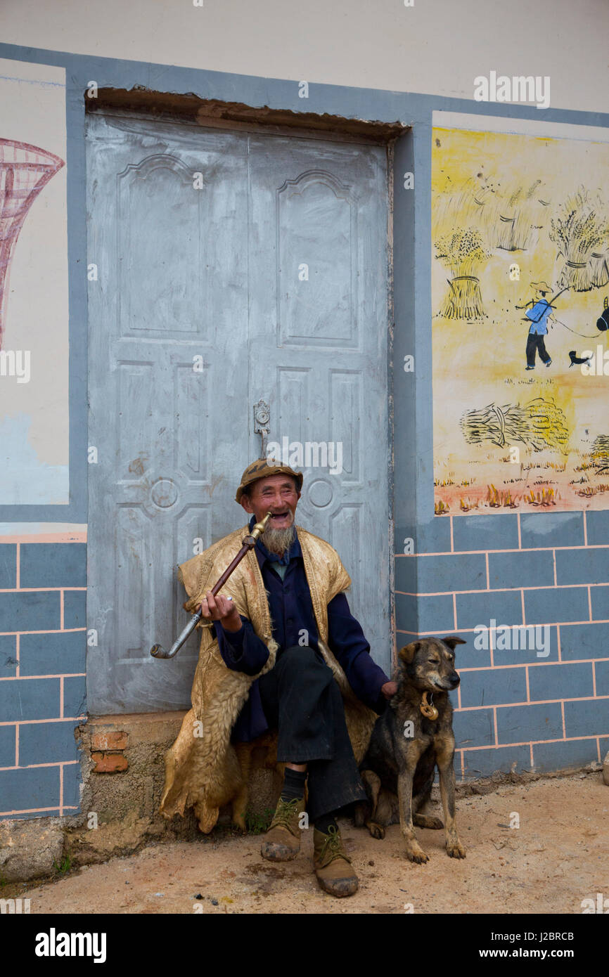 Older Chinese Gentleman with his pipe and dog, Dongchuan red Lands of ...