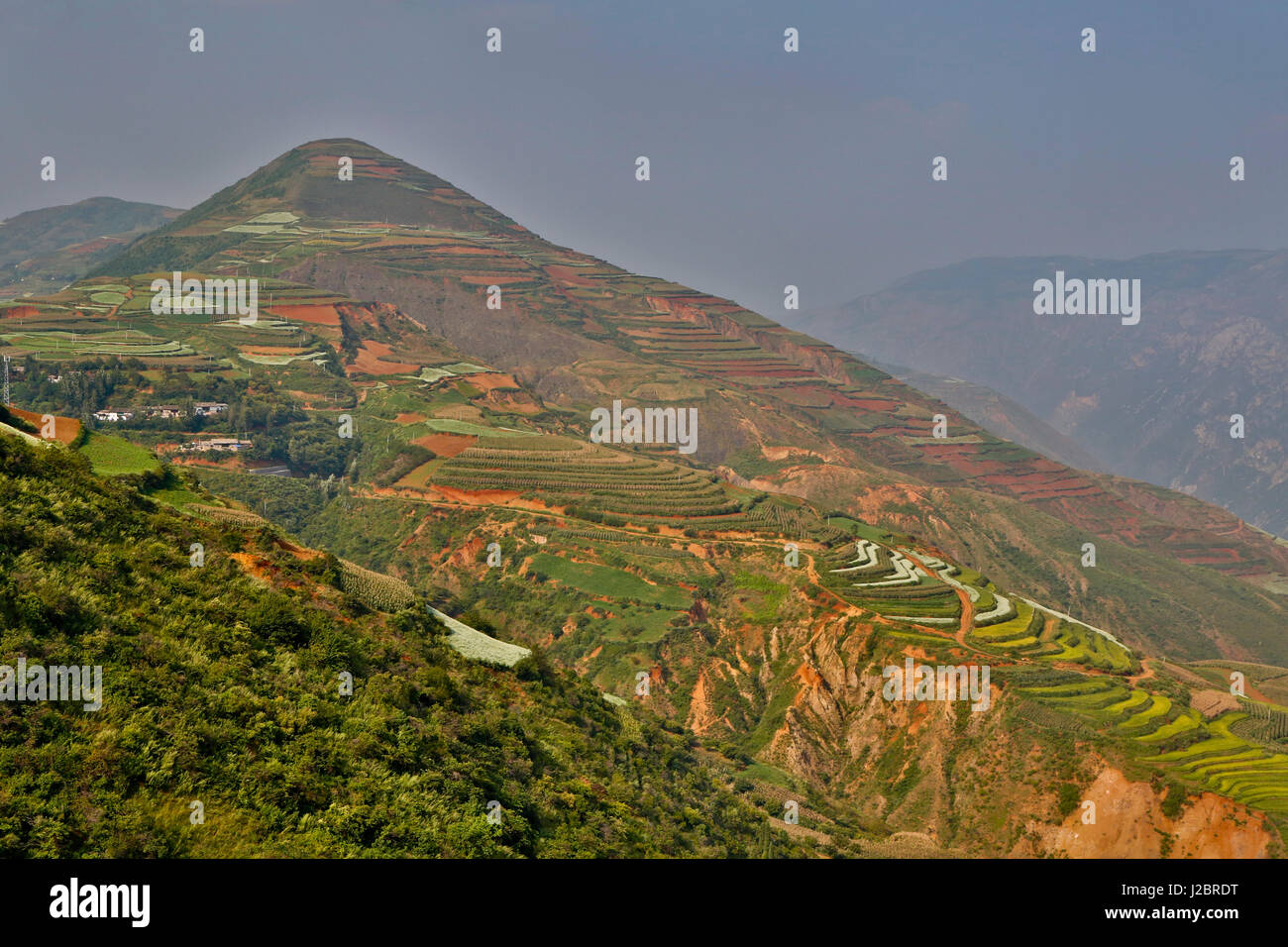 Kunming Dongchuan Red Land, China with crops in the red soil canola ...