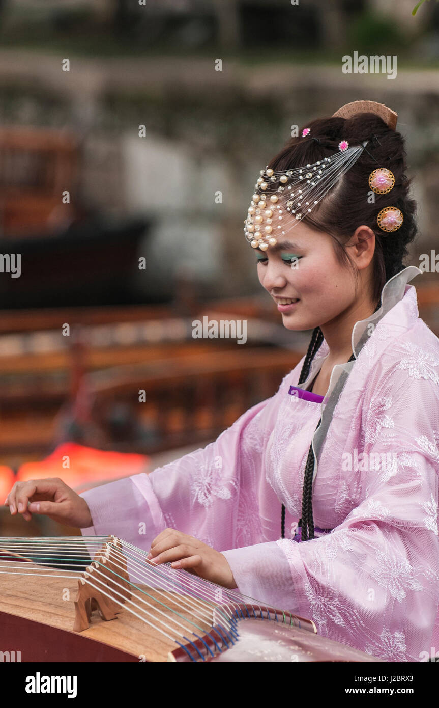 Girl playing the Guzheng in the water village of Tongli, China Stock ...