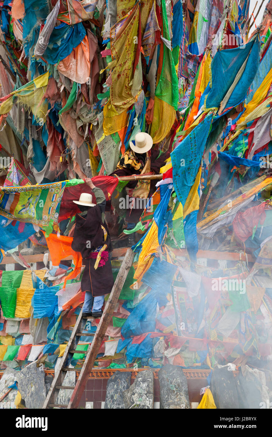 Wind Horse of Buddhist prayer flags being arranged by Tibetan men at ...