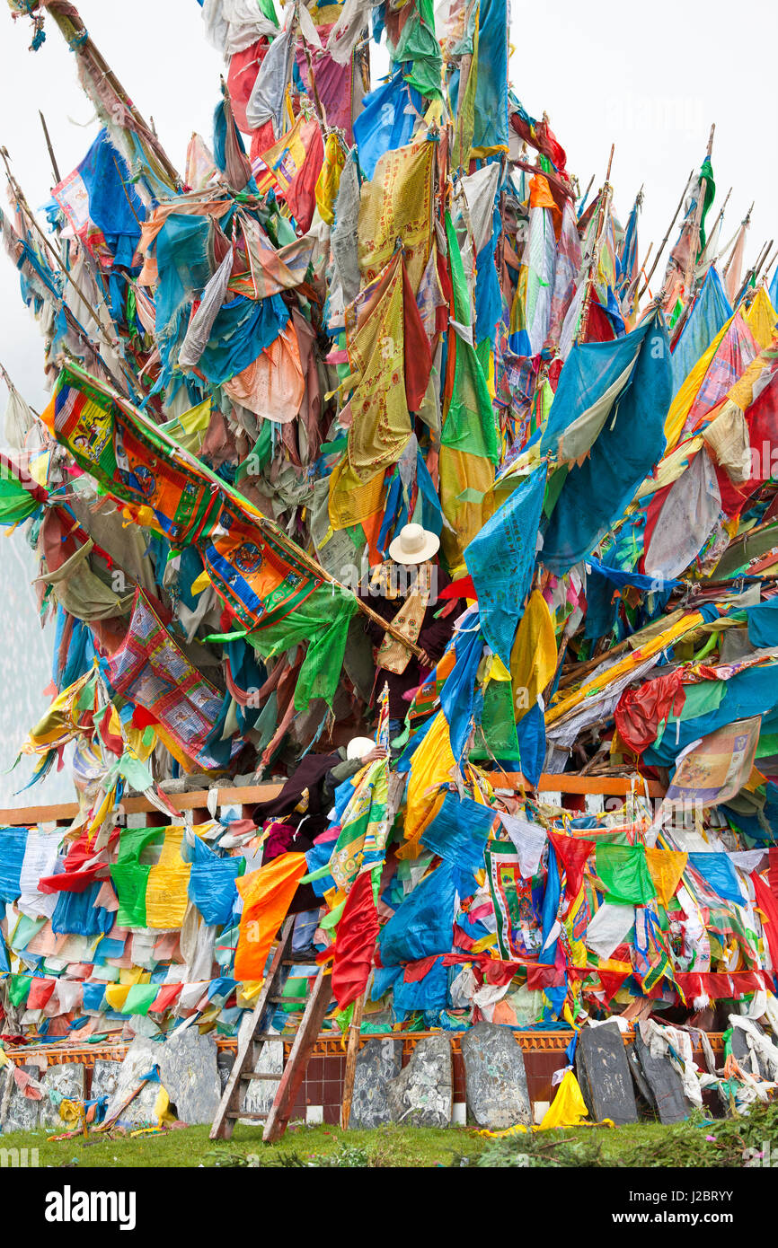 Wind Horse of Buddhist prayer flags being arranged by Tibetan men at ...