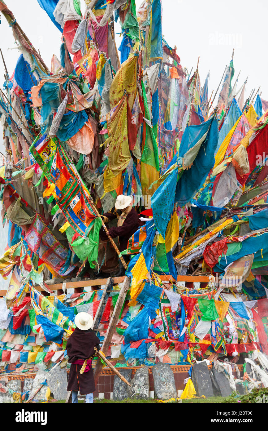 Wind Horse of Buddhist prayer flags being arranged by Tibetan men at ...