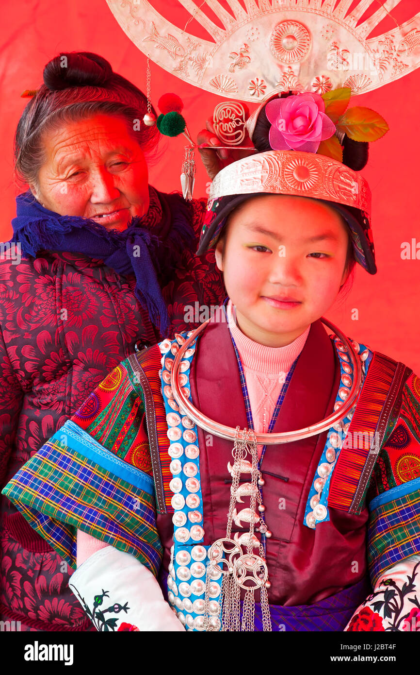 Young Black Miao girl preparing for festival, Kaili, Guizhou Province ...