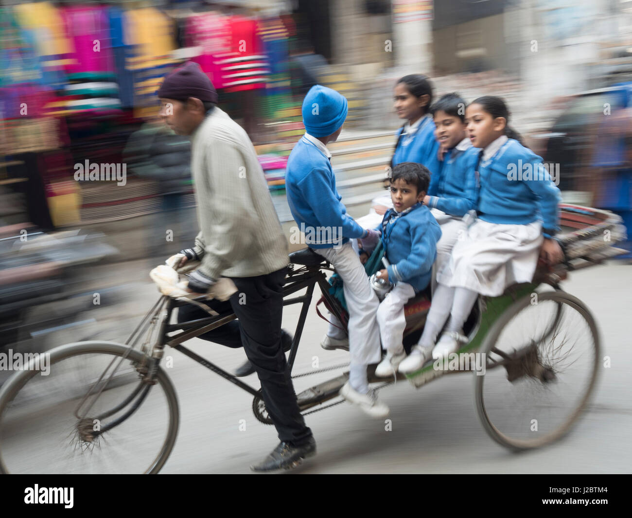 Rickshaw driver taking children to school in Amritsar, Punjab, India ...