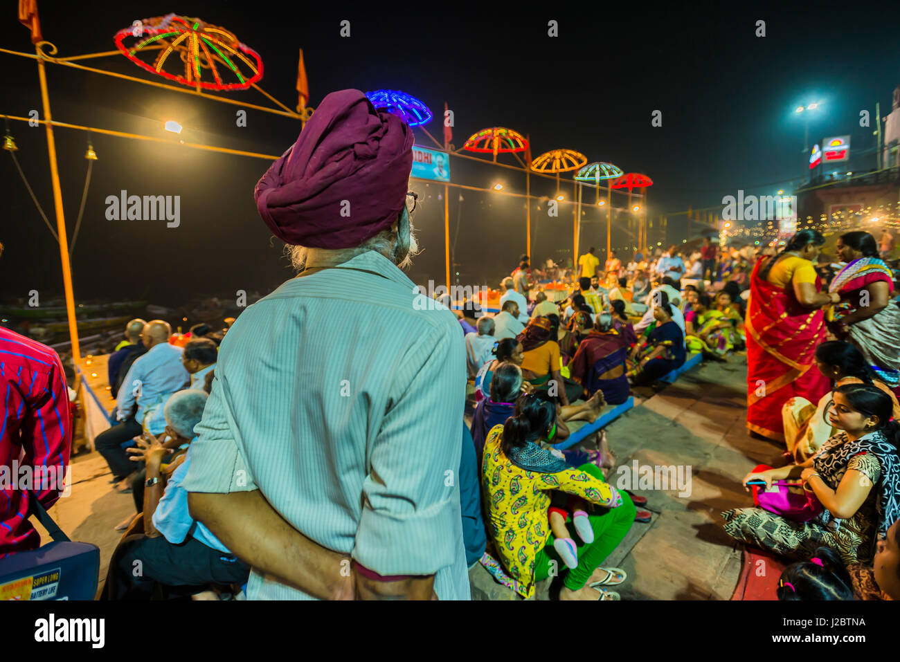 India, Varanasi tourists mix with Hindu devotees at the Ganga Arti ...
