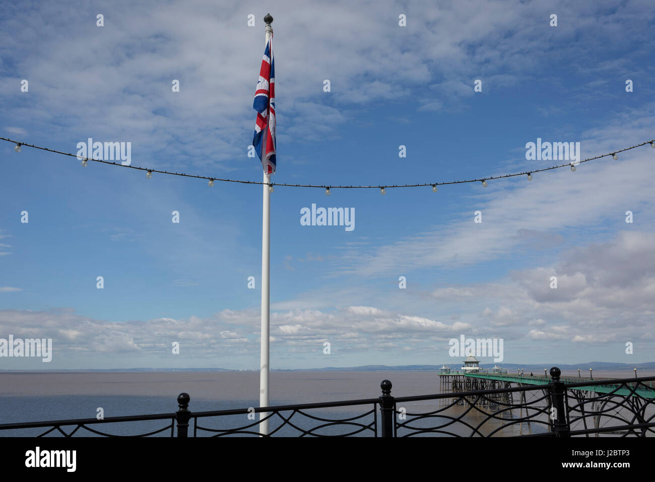 A sad looking Union jack flag hanging from a flagpole at the seaside ...